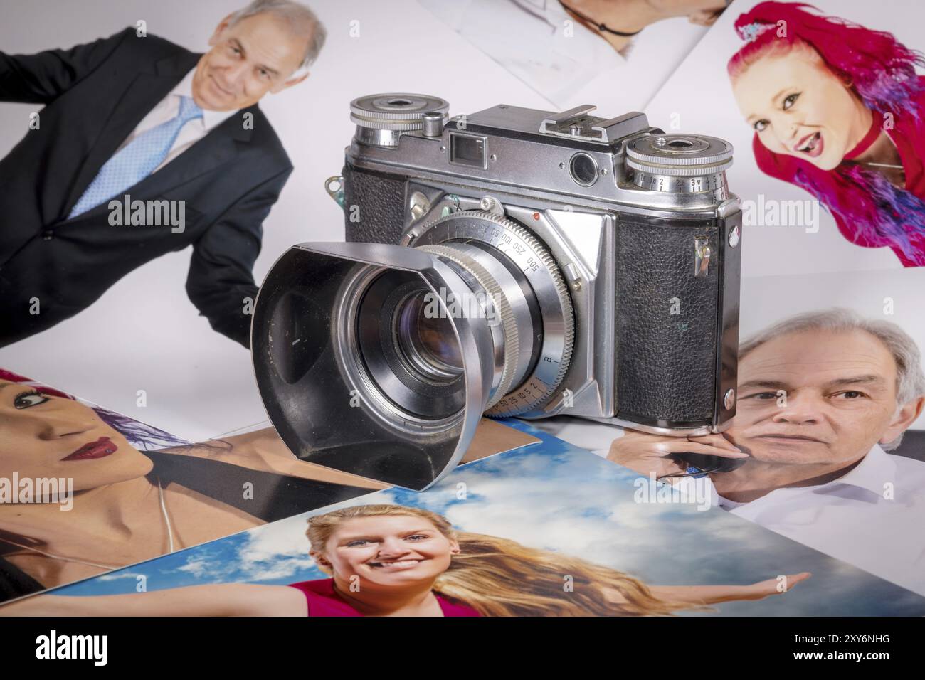 Old camera lies on several pictures with portraits of people Stock ...