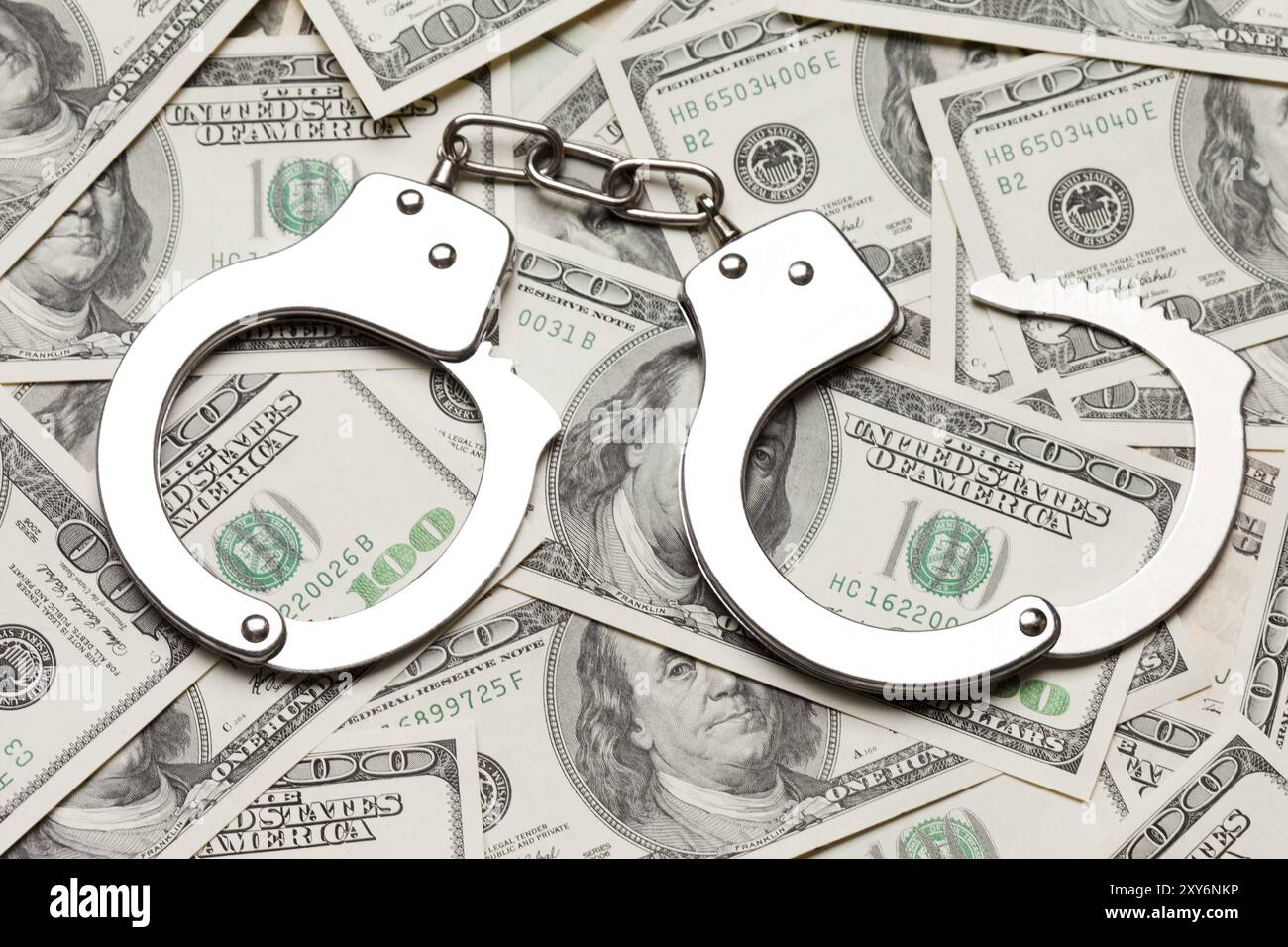 Crime law handcuffs arrests paper dollars currency Stock Photo - Alamy