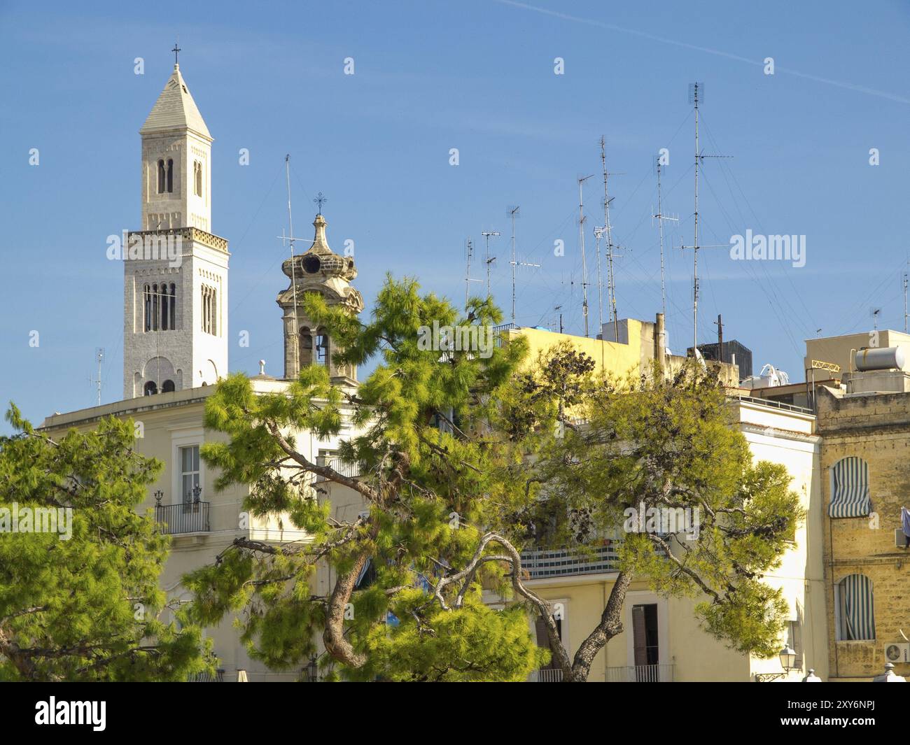 City view with prominent tower, buildings, antennas on roofs and green ...