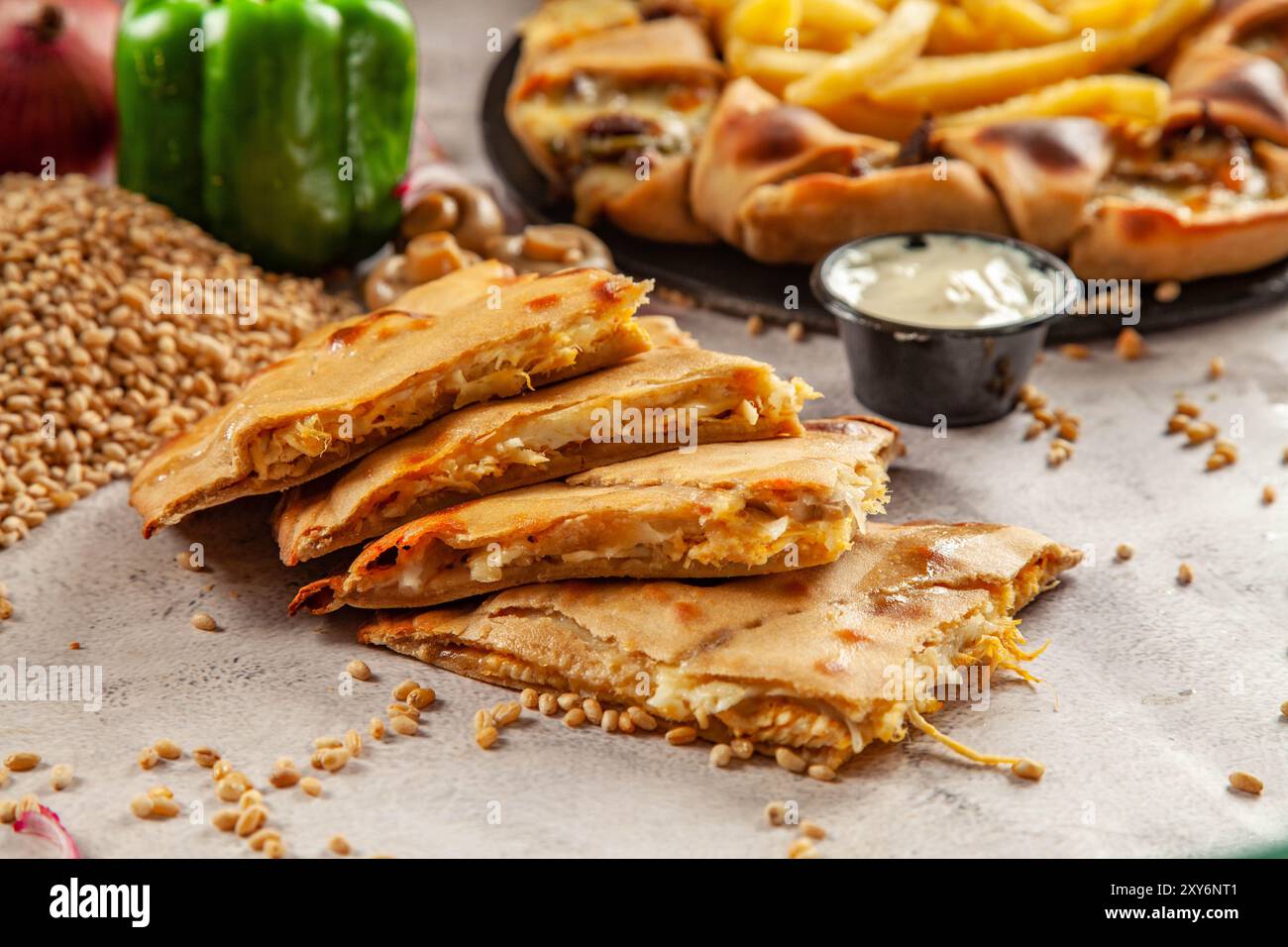 Whole wheat stuffed naan with barley and ingredients in the background ...