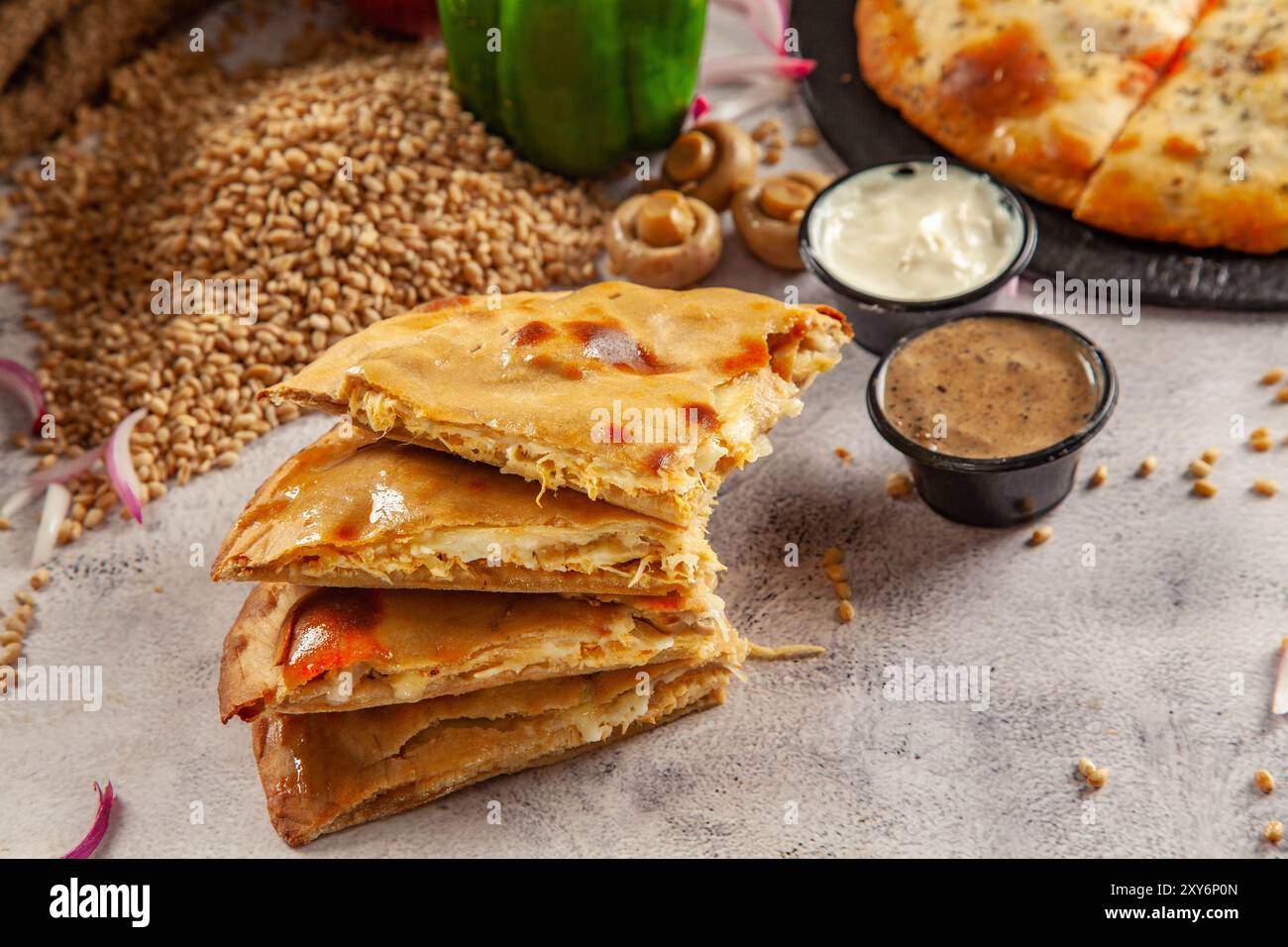 Whole wheat stuffed naan with barley and ingredients in the background ...