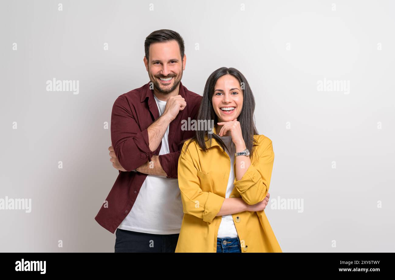 Portrait of confident young boyfriend and girlfriend smiling and posing ...