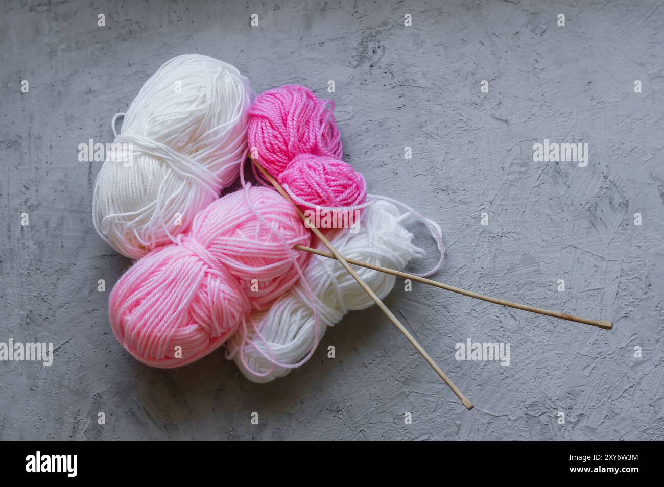 Colorful tangles of yarn, wool cotton yarns with needle for knitting ...