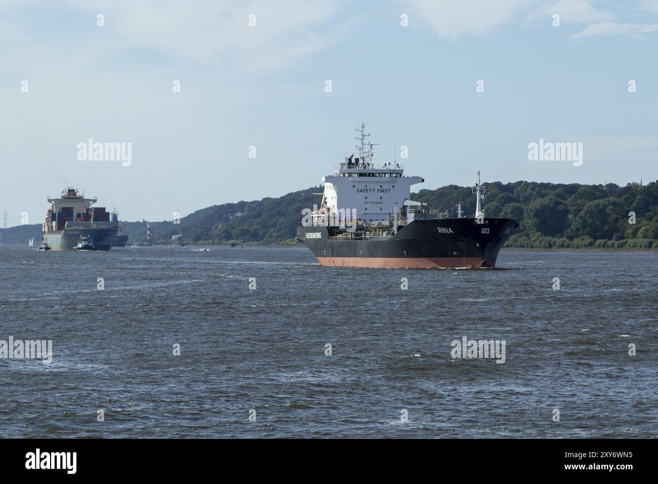 Tanker Rina and a container freighter on the Elbe entering the harbour ...