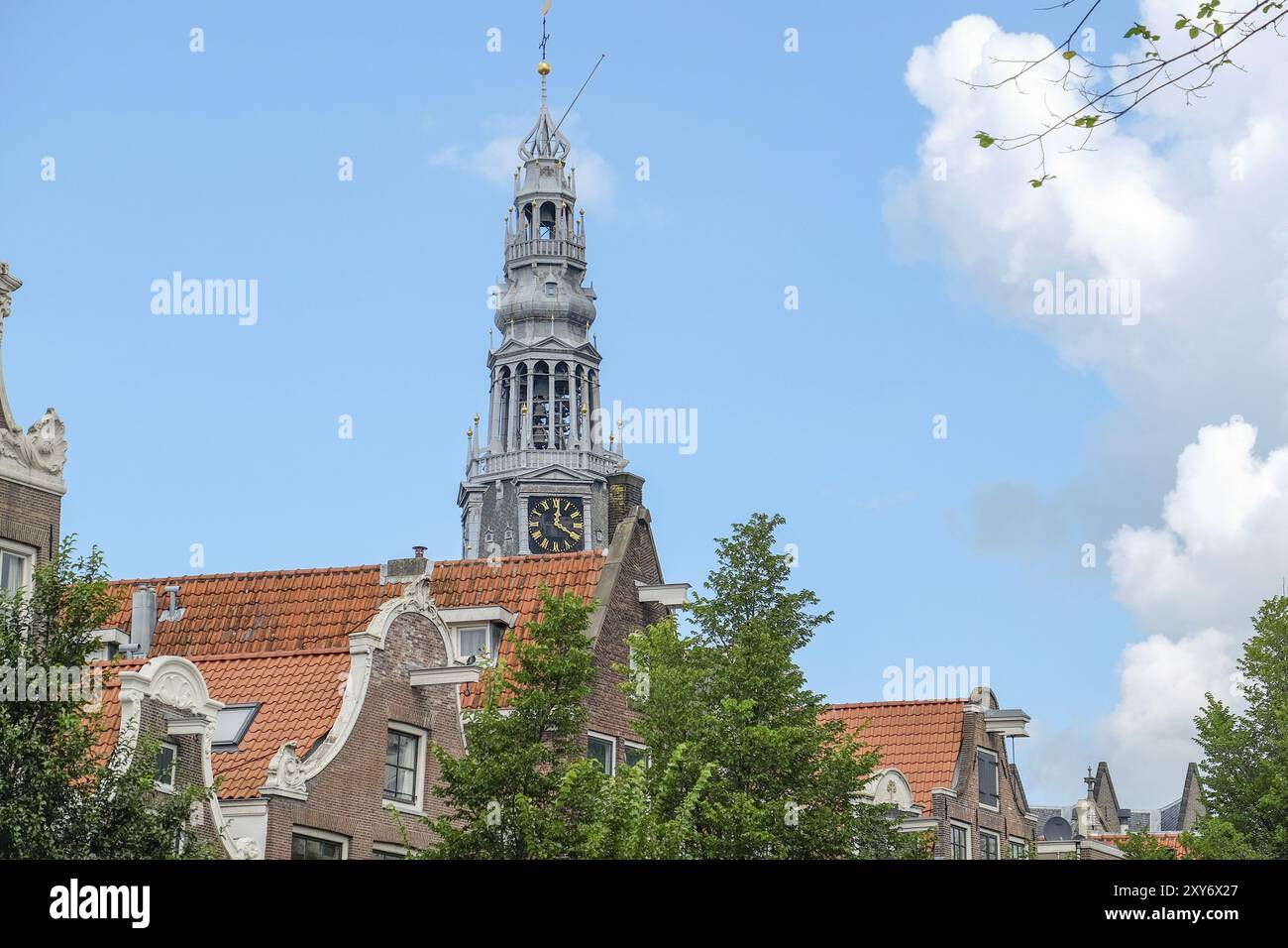 A church tower with a clock towers above the historic gabled houses ...