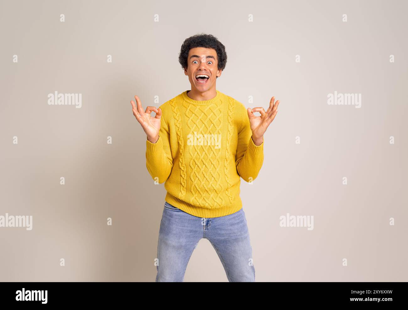 Portrait of satisfied businessman laughing and showing OK signs while ...