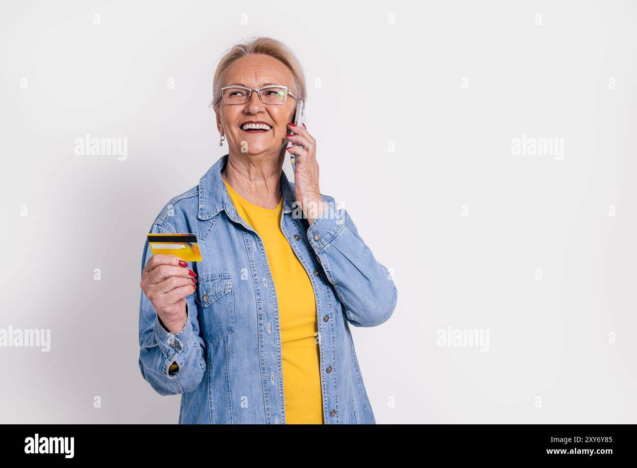 Happy old female customer sharing credit card details over call and ...