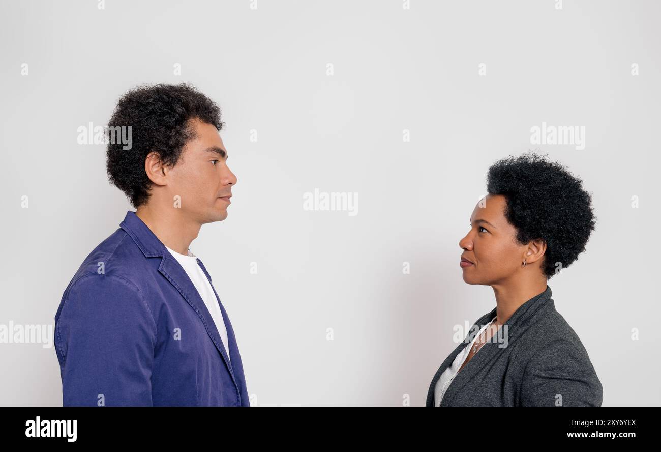 Side view of businessman and businesswoman confronting each other while ...