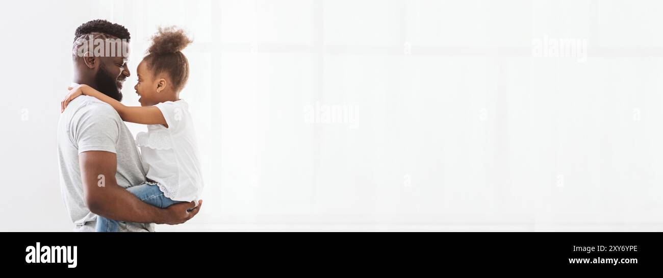 Black Father Holding His Daughter While Enjoying Quality Time Together Stock Photo - Alamy