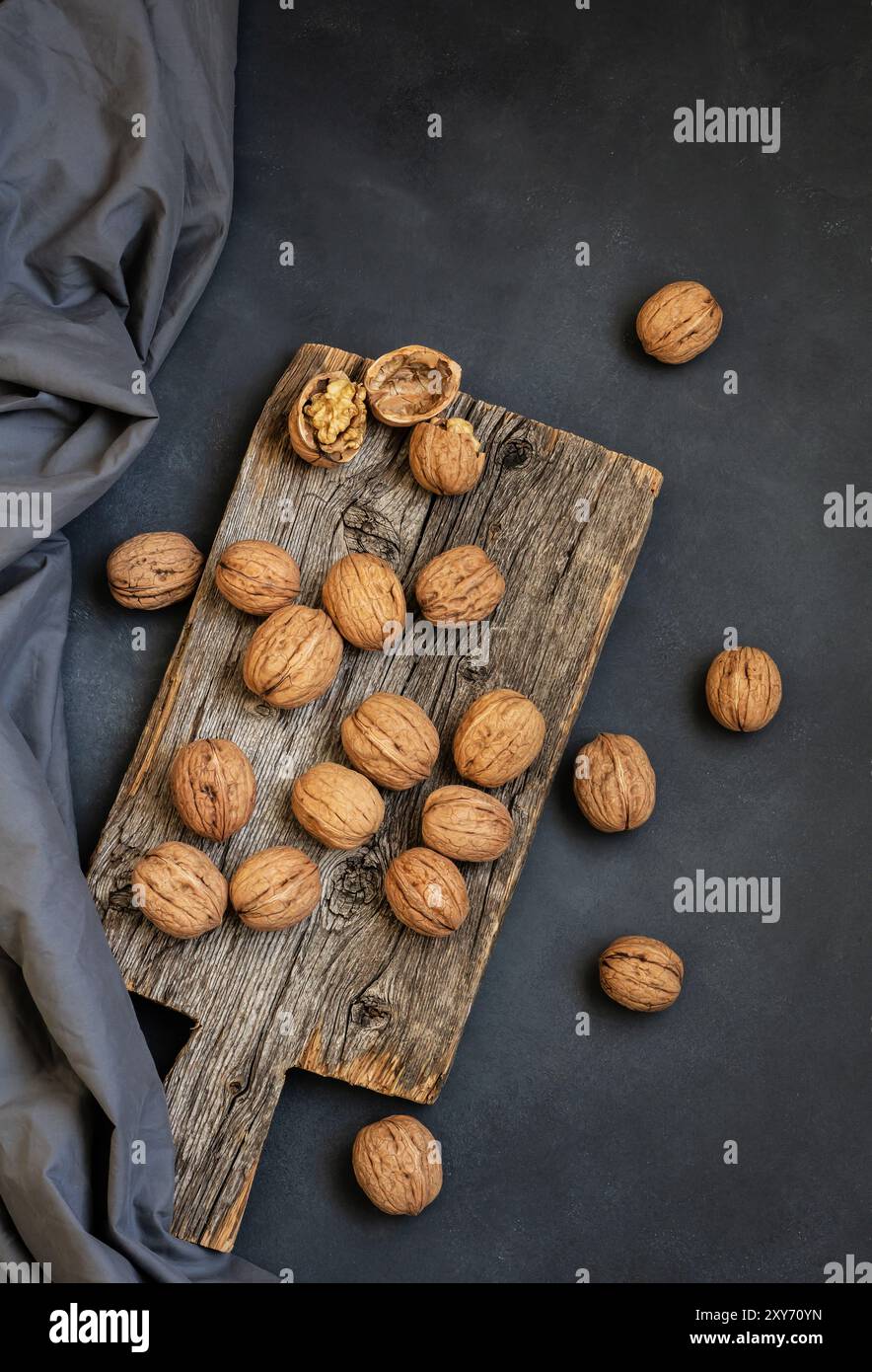 Ripe and raw whole big walnut kernel with shell on rustic backdrop ...