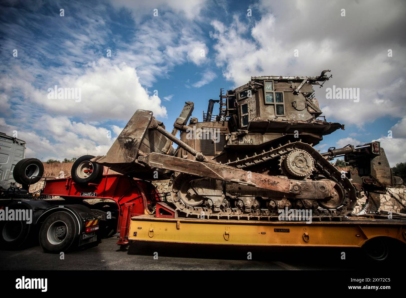 An Israeli military armored bulldozer is seen loaded out of the Far'a ...
