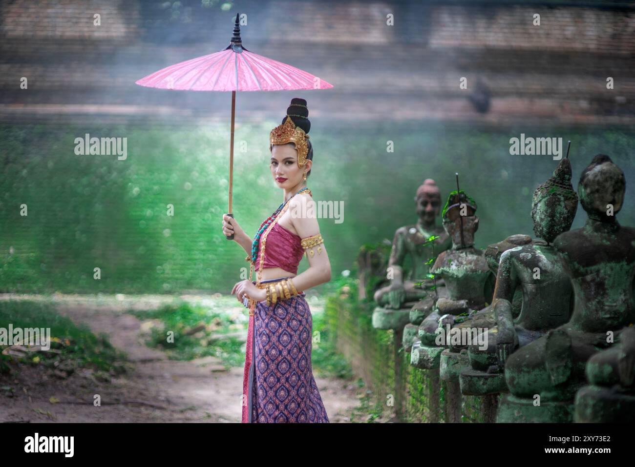 Beautiful young ASEAN woman in traditional Thai Dvaravati dress in an ...