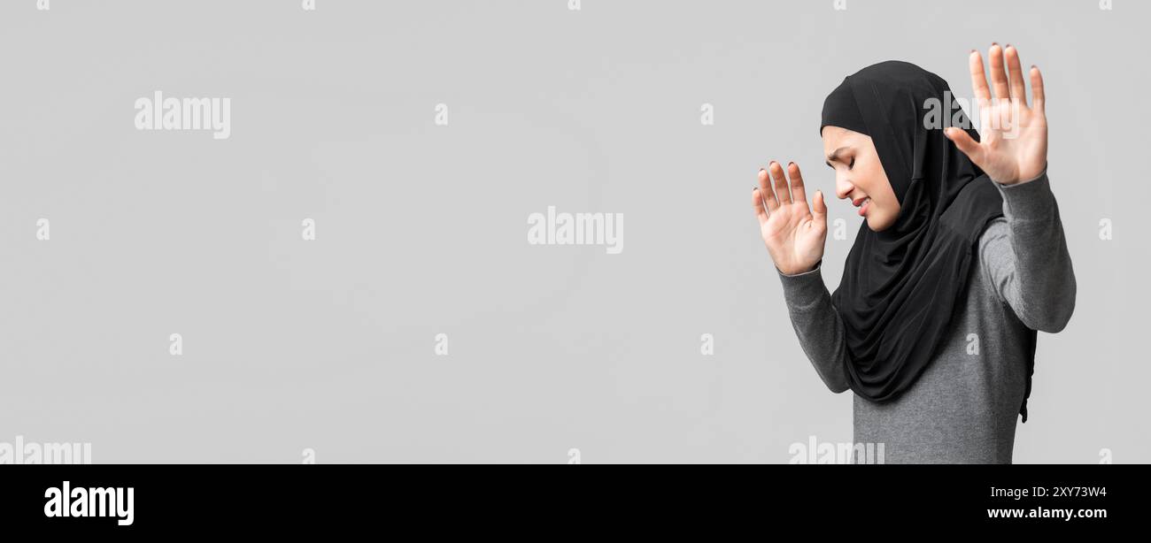 Scared muslim woman gesturing stop, trying to protect herself from ...