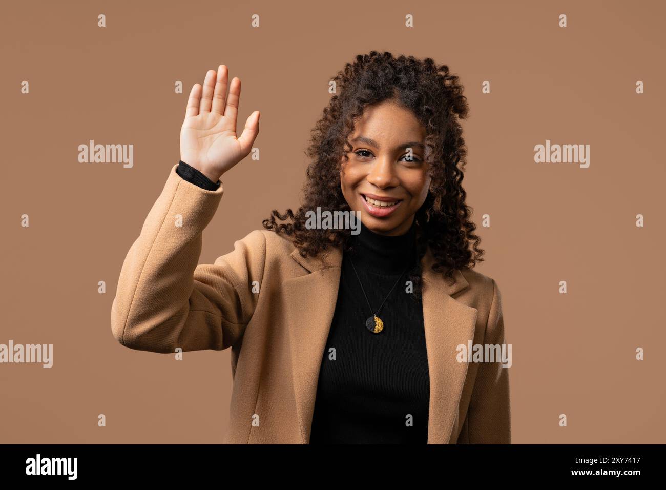 Friendly young teenager girl waving hand - hello, or goodbye, chao ...