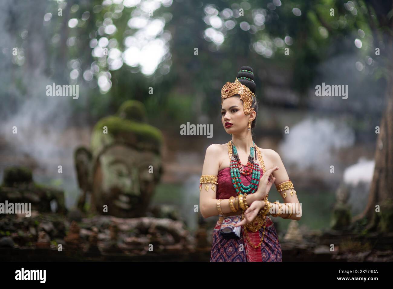 Beautiful young ASEAN woman in traditional Thai Dvaravati dress in an ...