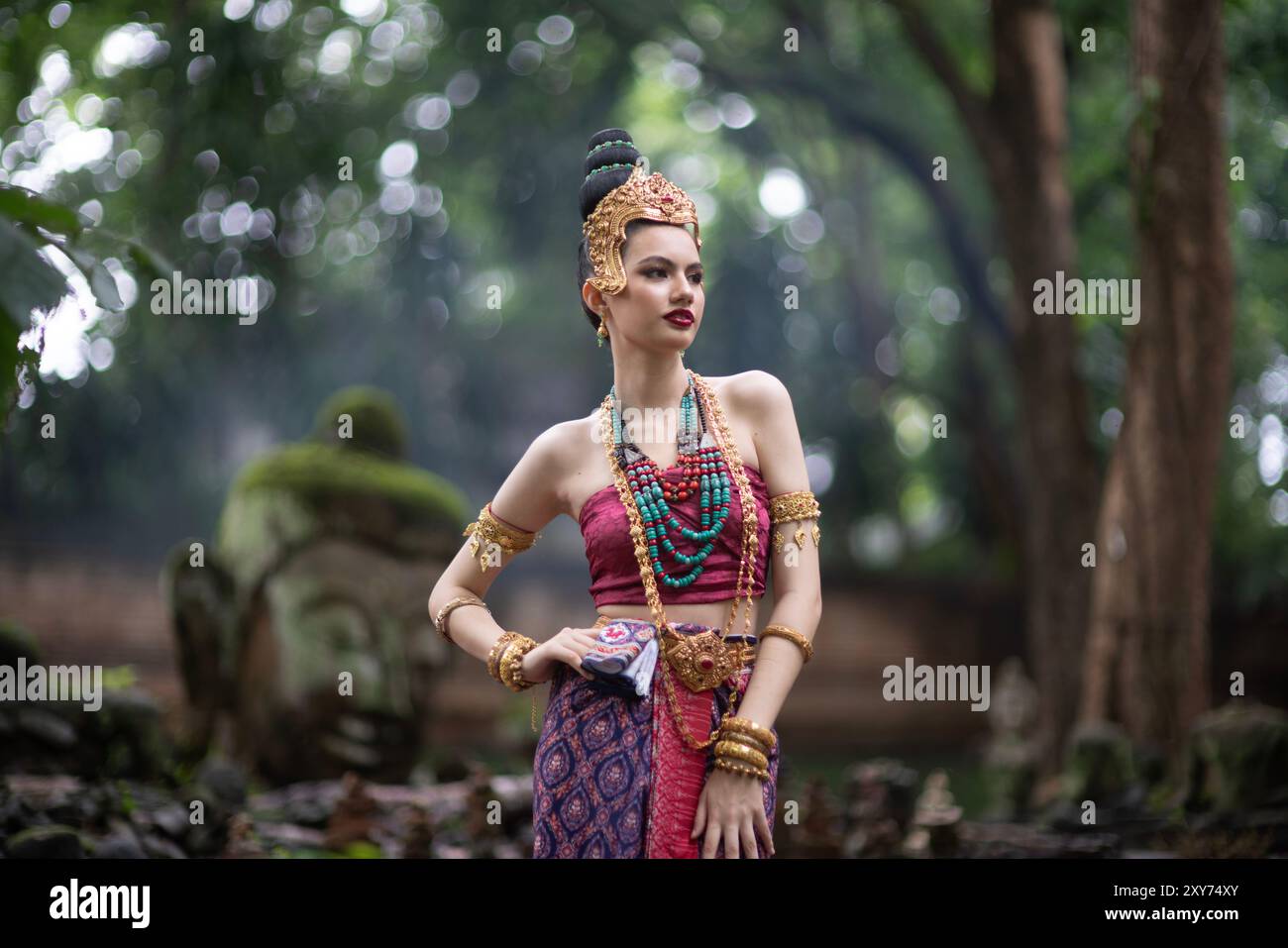 Beautiful young ASEAN woman in traditional Thai Dvaravati dress in an ...
