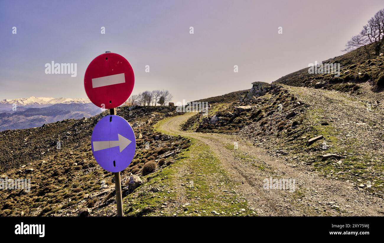 Road signs in front of a fork on a gravel road in the mountains, Lefka ...