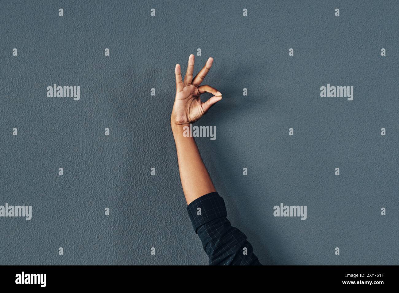 Perfect, gesture and hand of person on wall background with opinion ...