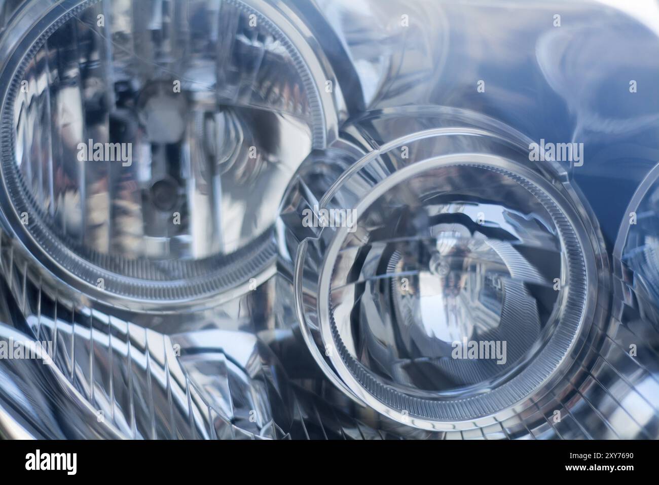 Silver blue background art, blurred close-up of a car headlight ...