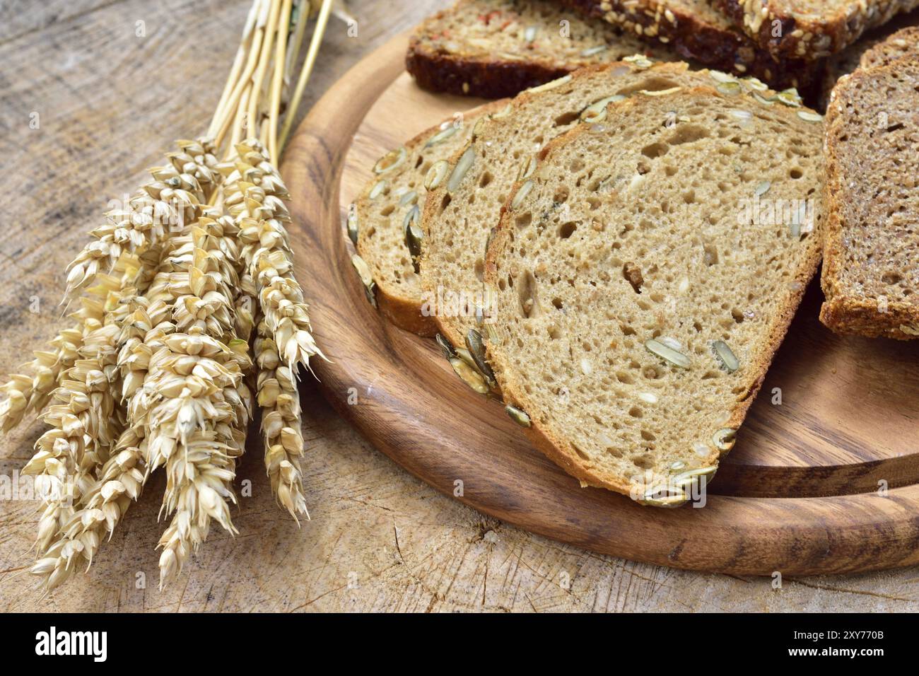 Top view of sliced wholegrain bread on a wooden table. Different types ...