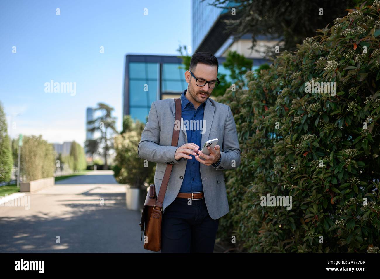 Portrait of male business professional texting over smartphone while ...