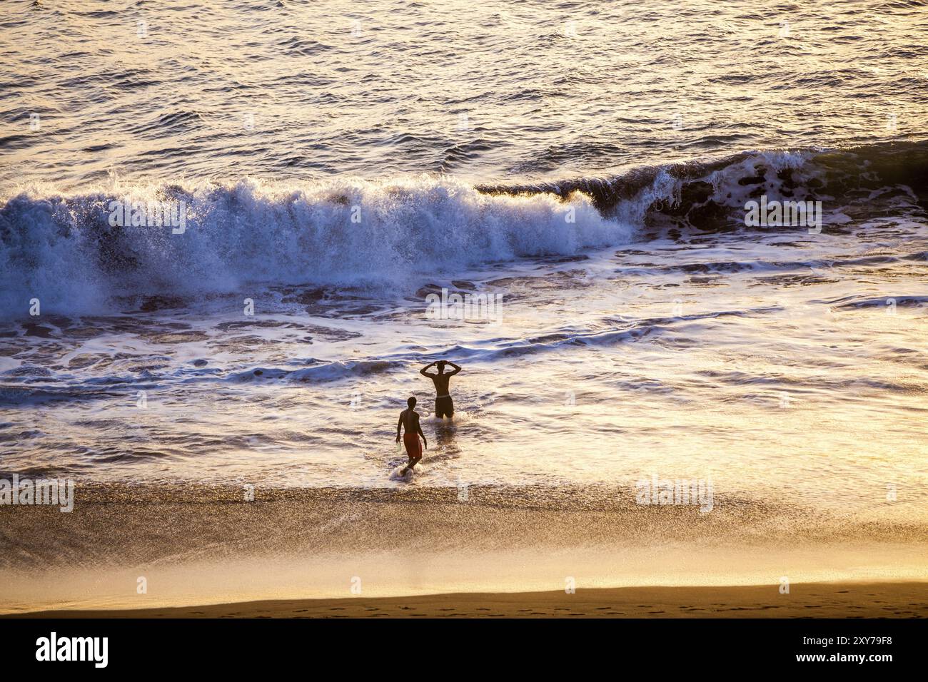 A group of young men having fun on the beach Stock Photo - Alamy