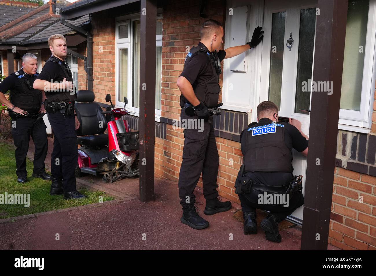 Cleveland Police officers raid a home in Middlesbrough during a day of ...