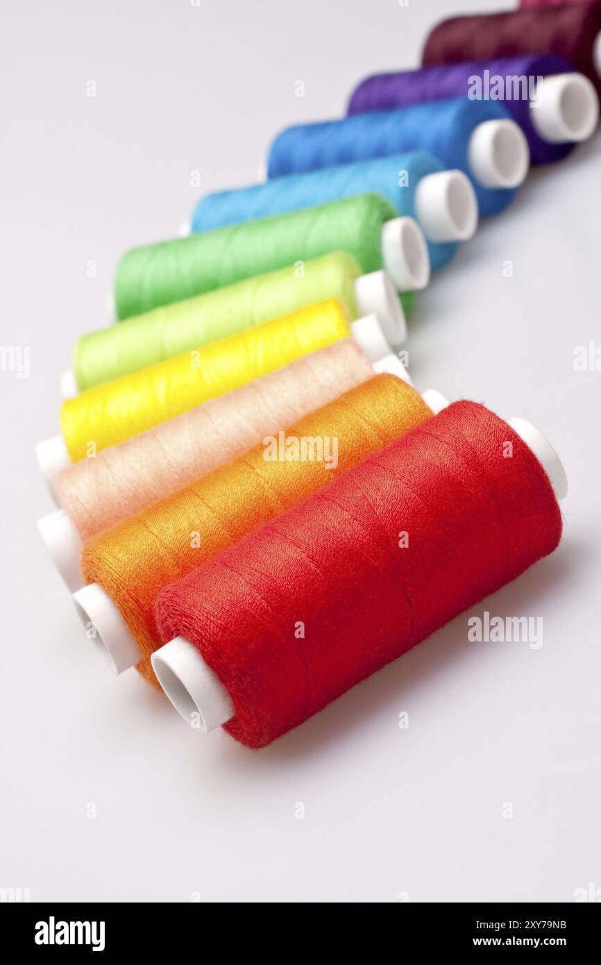 Multi-colored rainbow threads for sewing Stock Photo - Alamy