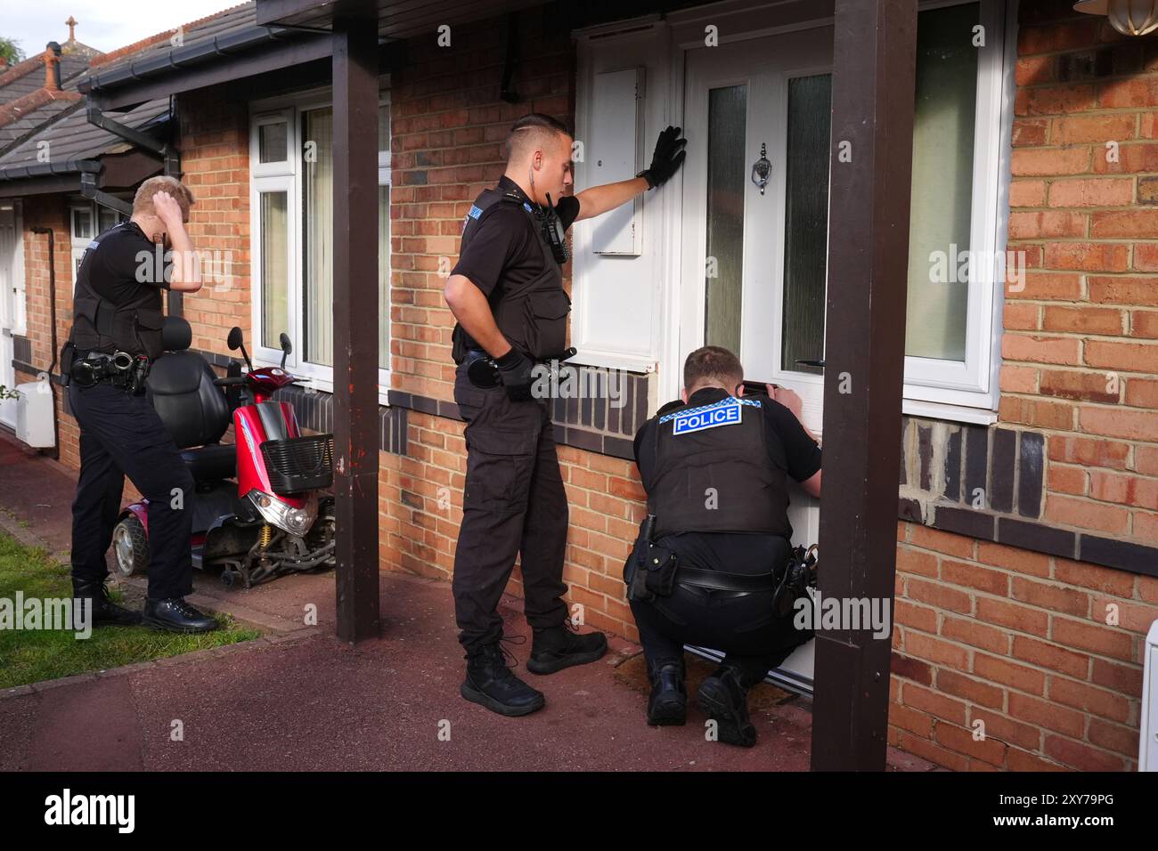 Cleveland police officers raid a home in middlesbrough during a day of ...