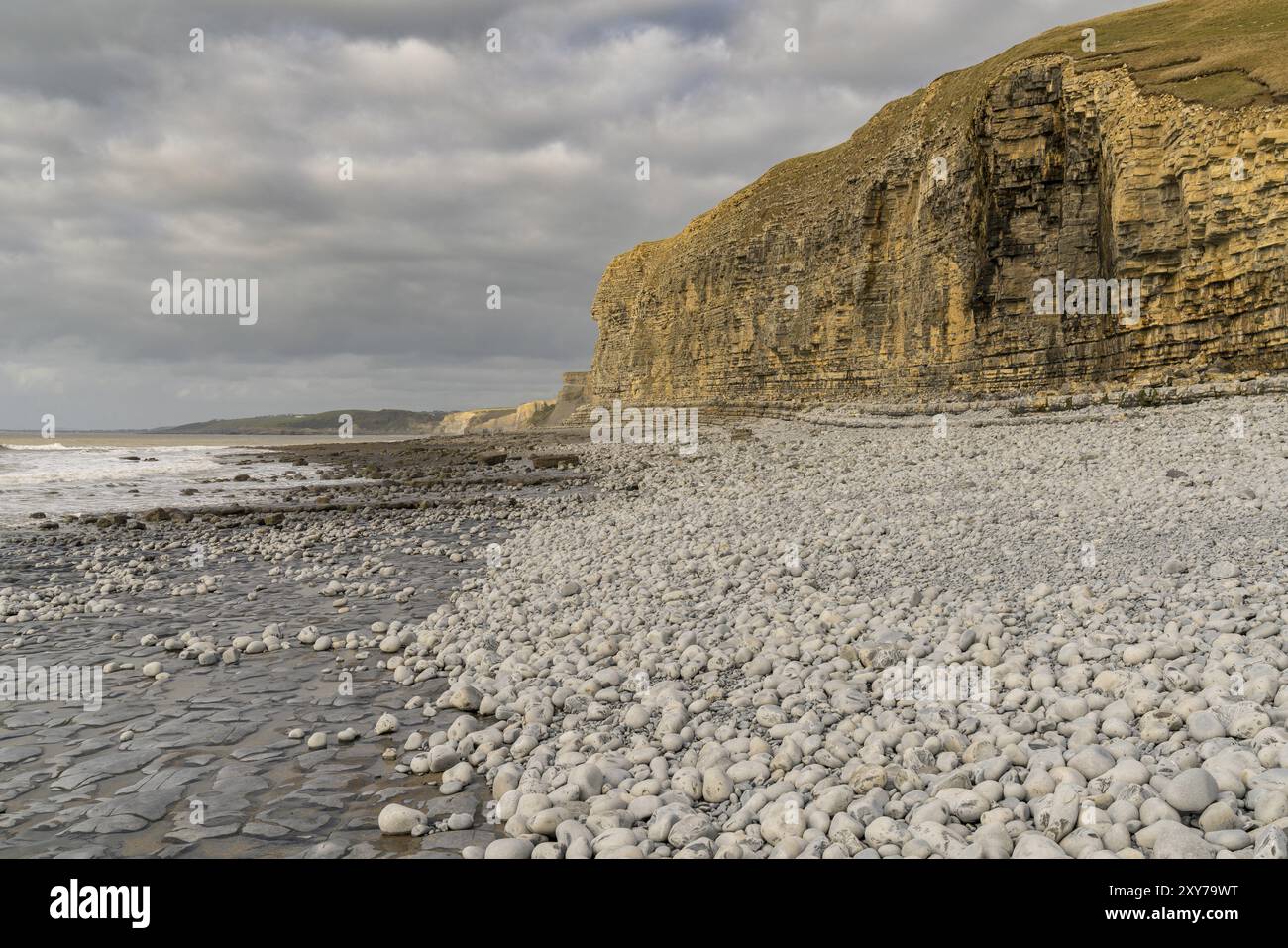 Stones and cliff on a cloudy day at Monknash Beach in South Glamorgan ...