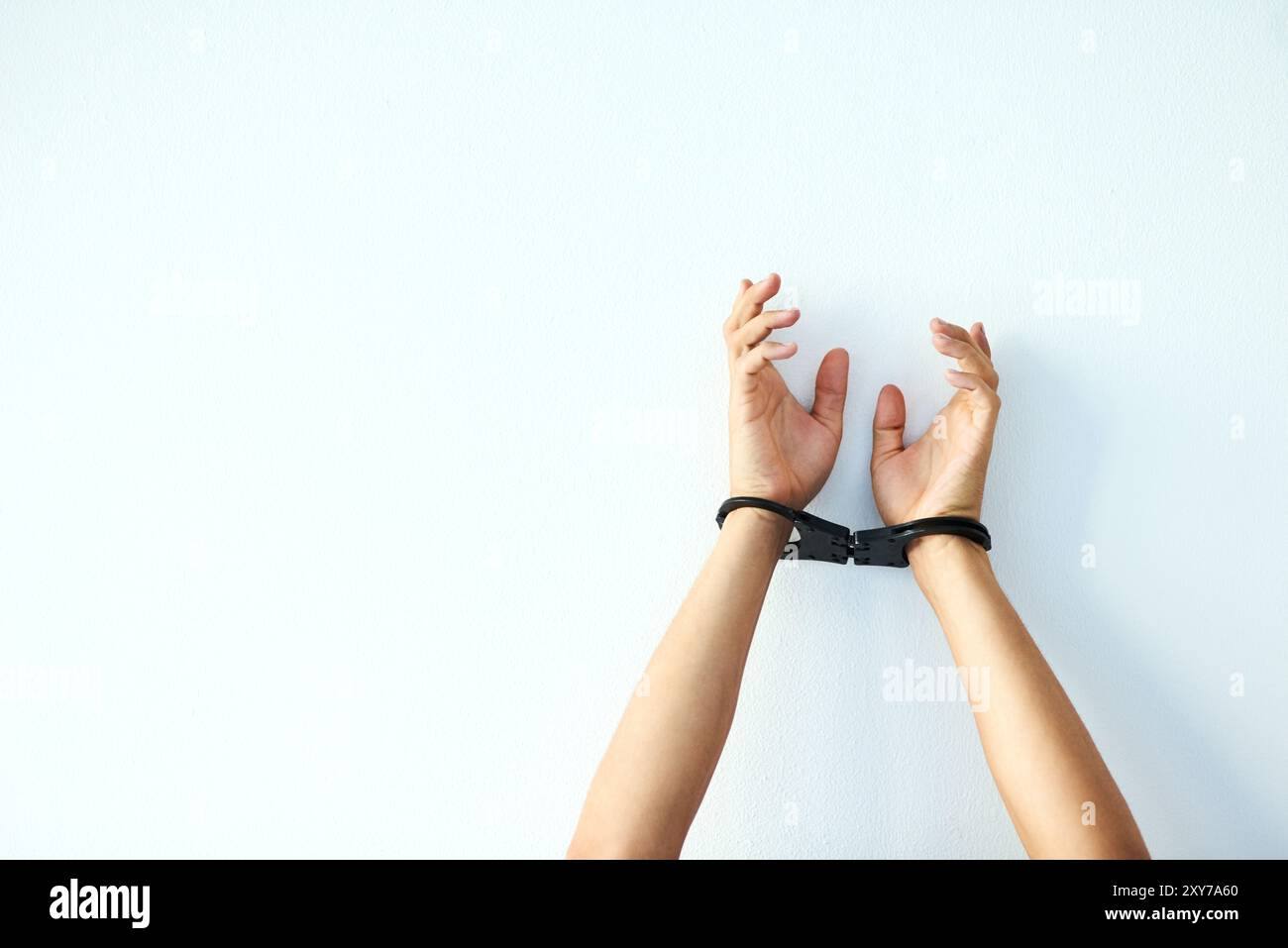 Hands, handcuffs and arms raised on white background with arrest and ...