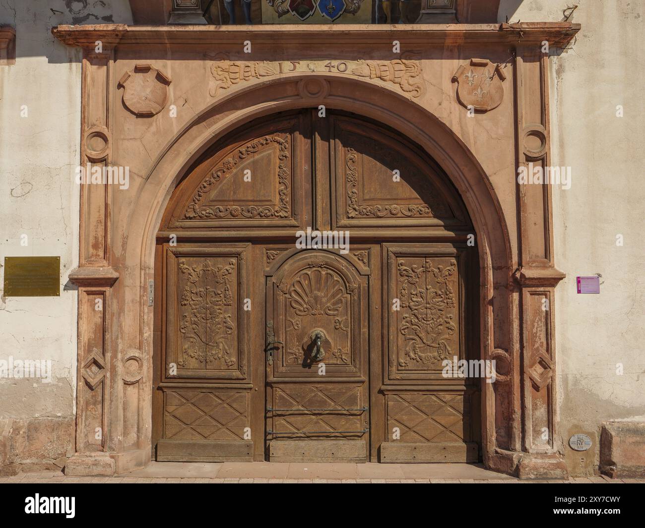 An ornately carved wooden gate in a historic building lends rustic ...