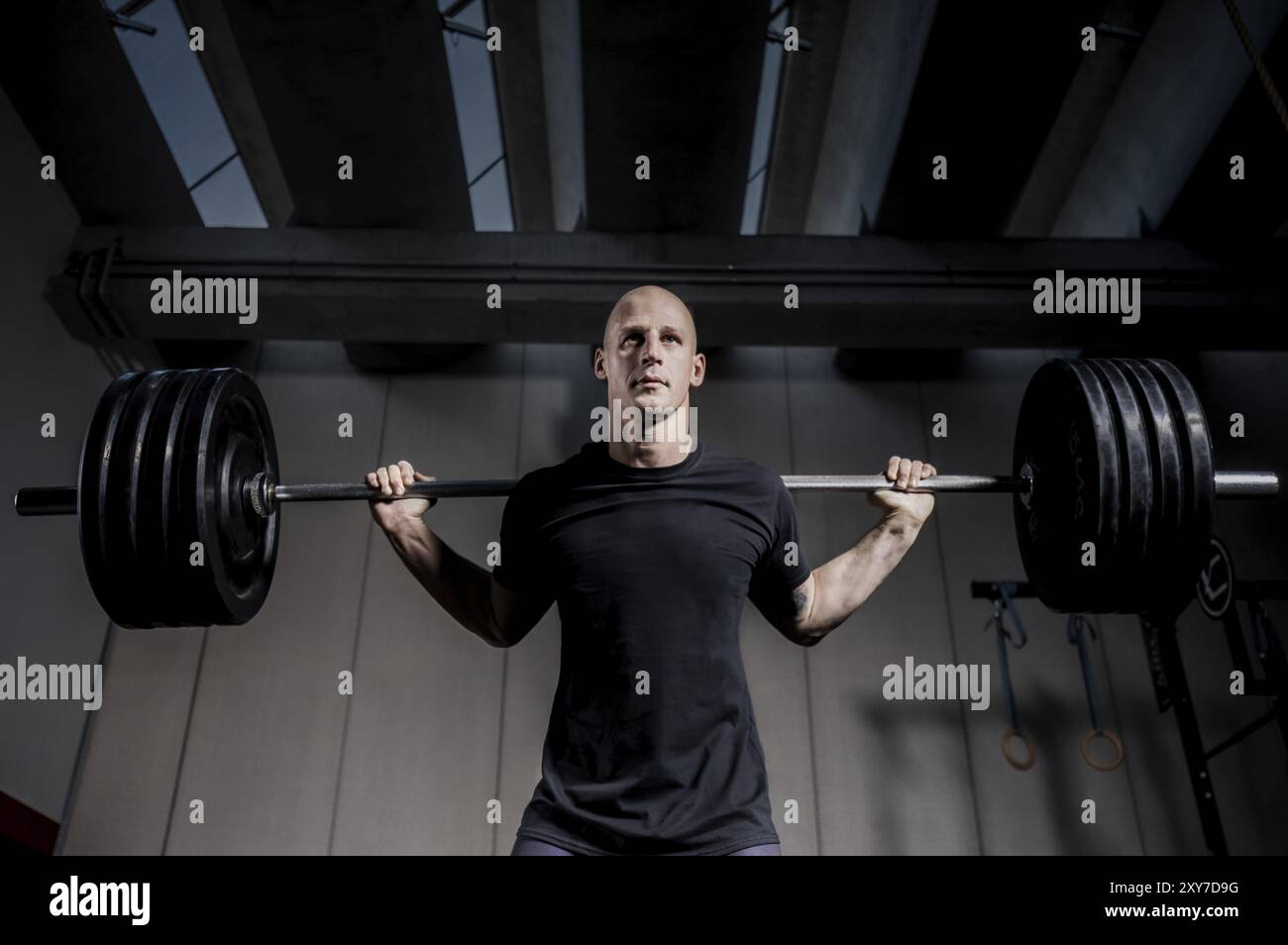Athletic Muscular Man Holding Barbell On His Shoulders at the Gym ...