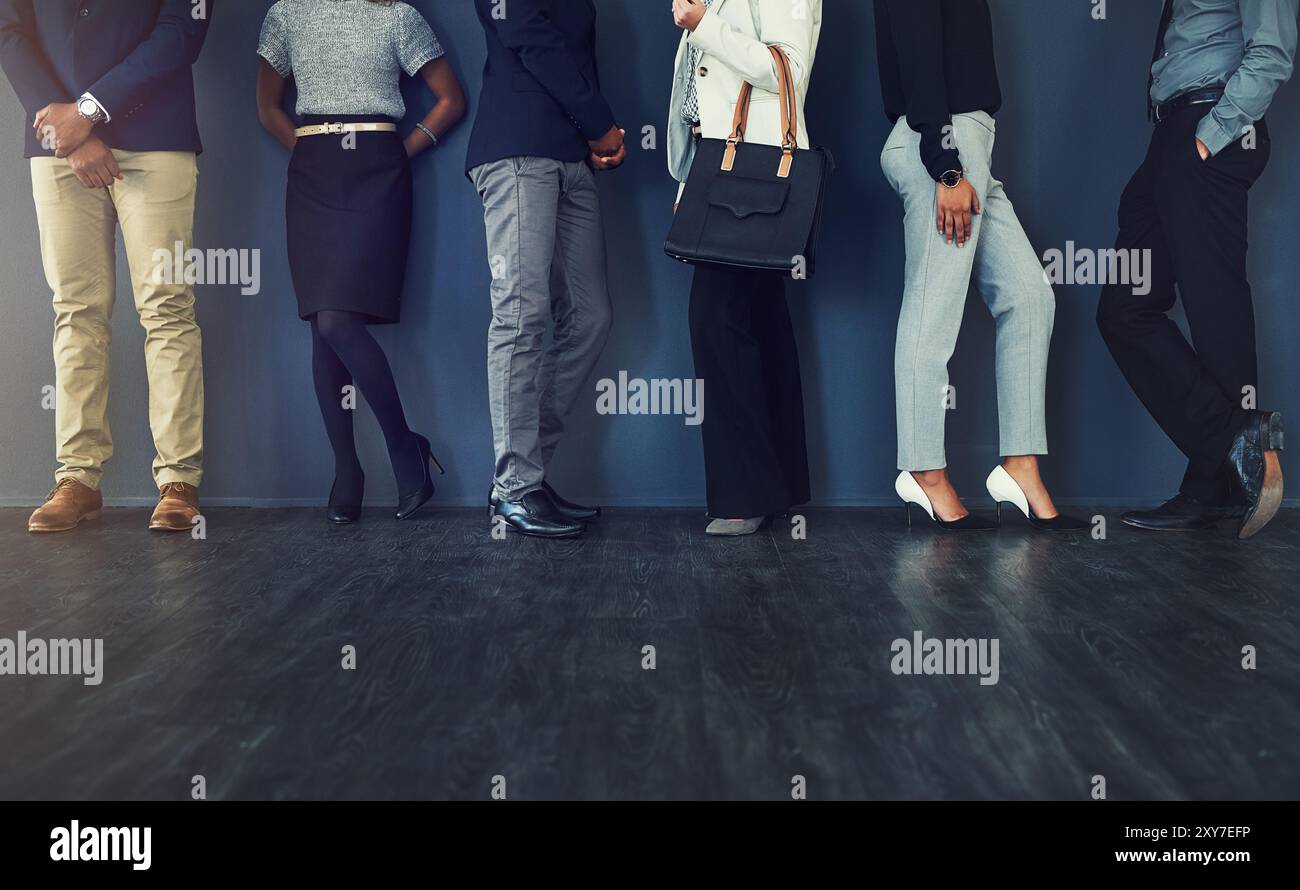 Waiting room, business people and legs in office for interview ...