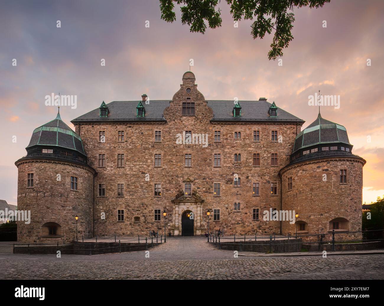 Medieval Orebro Castle is a fortification at Svartan river in sunset ...