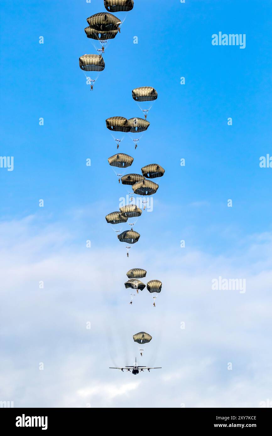 Military parachutist paratroopers parachute jumping out of an air force ...