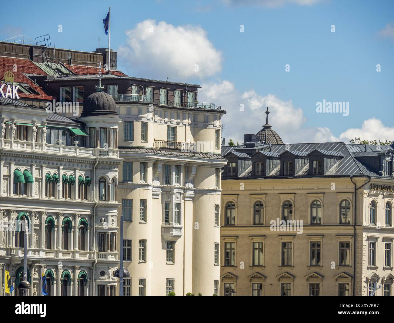 Classic buildings in a city under a blue sky with decorative facades ...