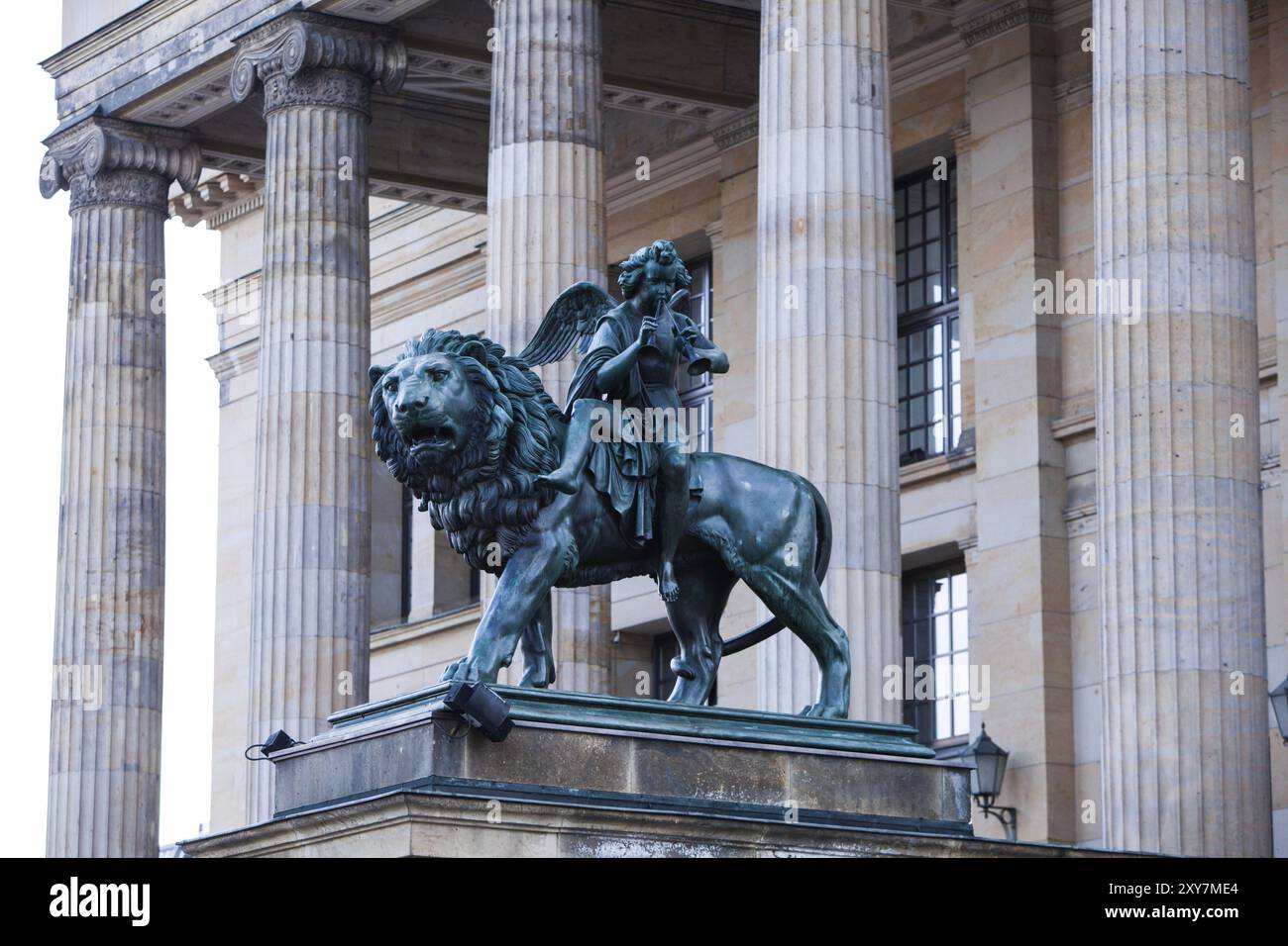 Angel plays two trumpets and rides a lion Stock Photo - Alamy