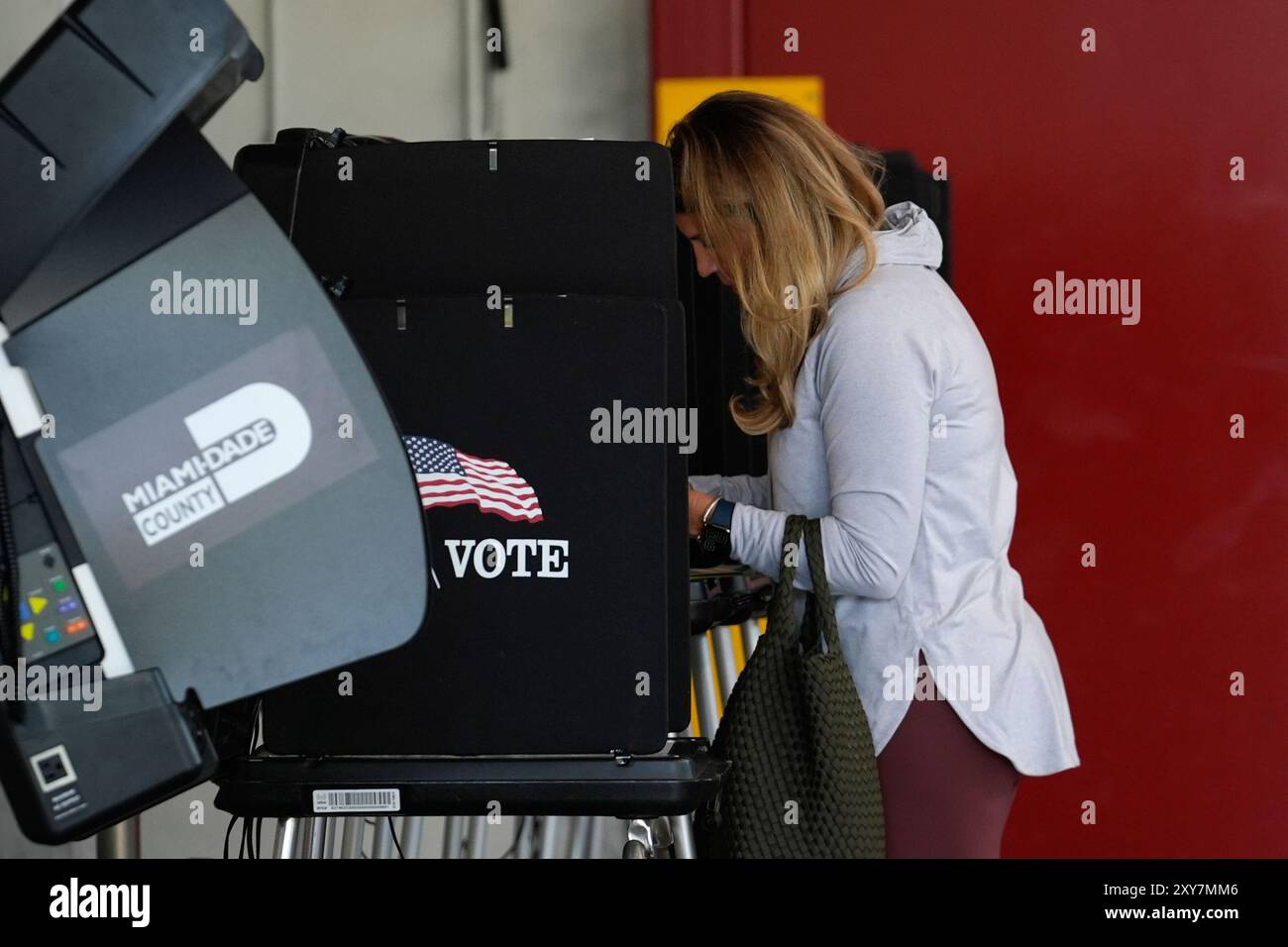 FILE - Voter Maria Mendoza completes her ballot for Florida's primary ...