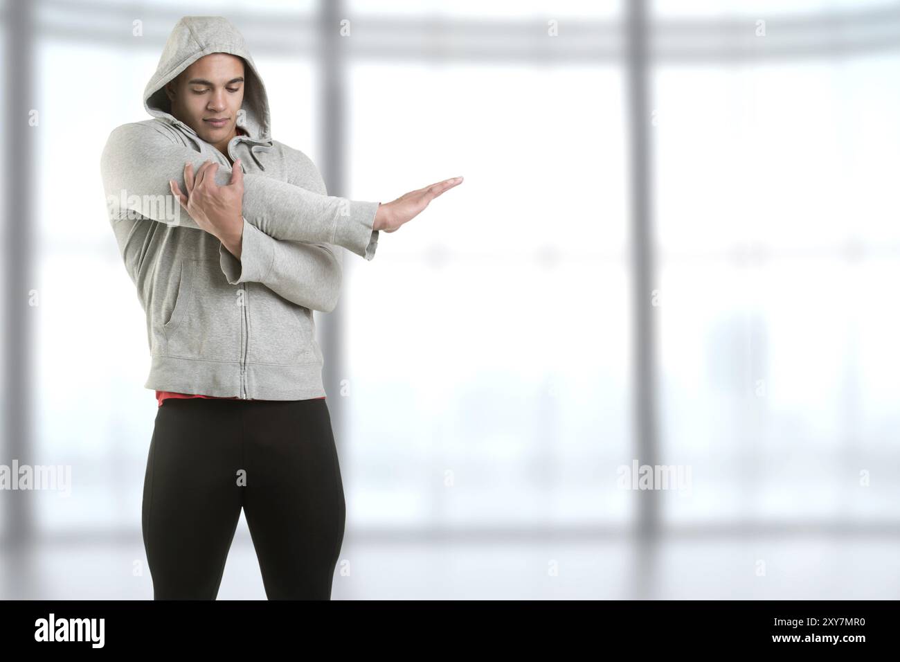 Fit man stretching his arm after working out Stock Photo - Alamy