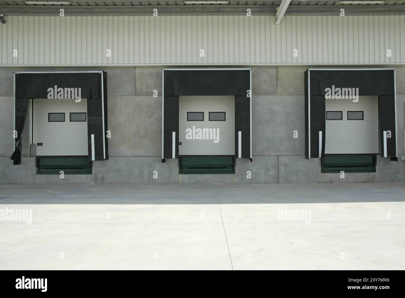 The loading area of a industrial warehouse with several loading bays ... The loading area of a industrial warehouse with several loading bays ...