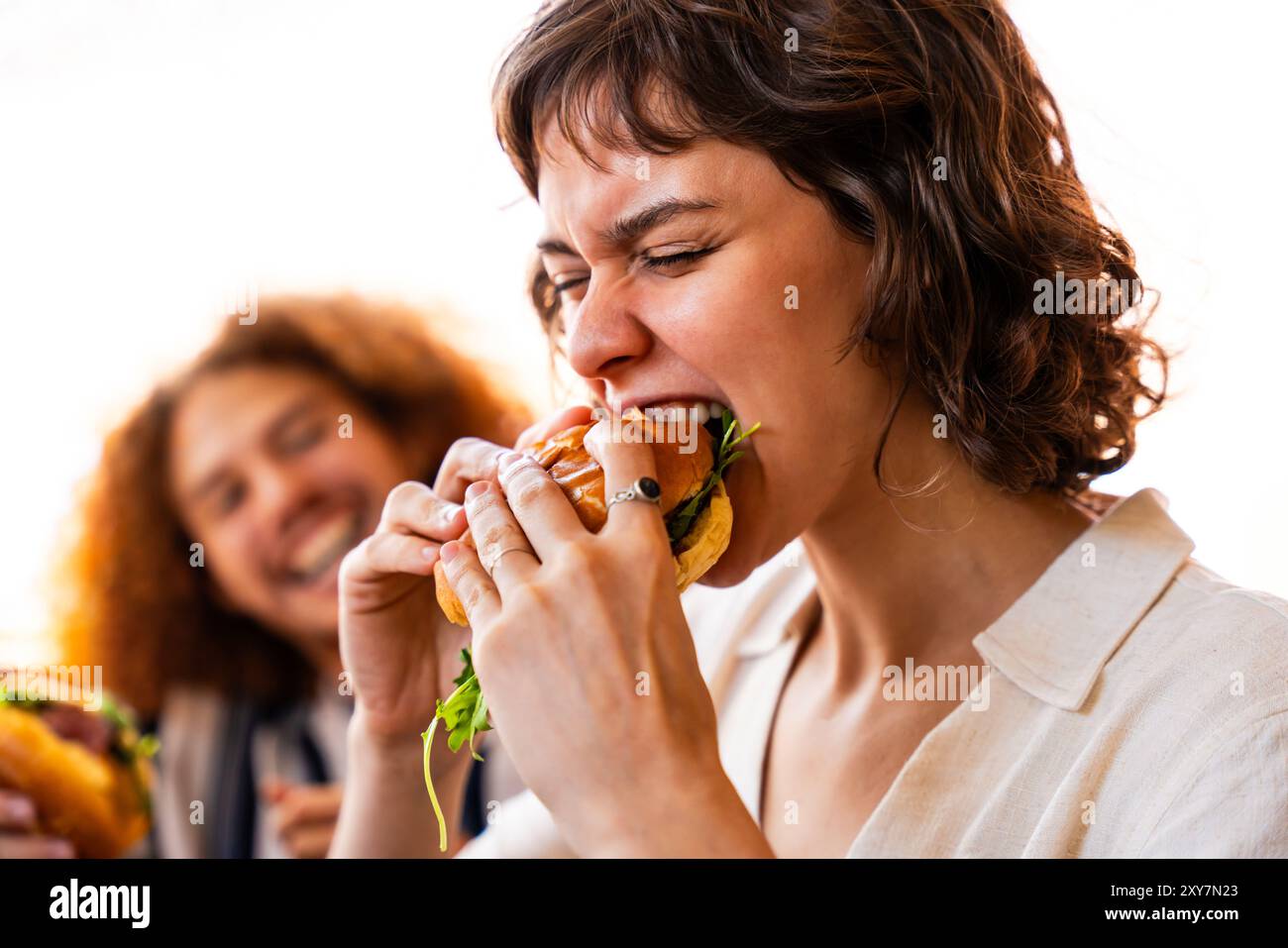 Multiethnic group of friends having meal at 80s vintage diner ...