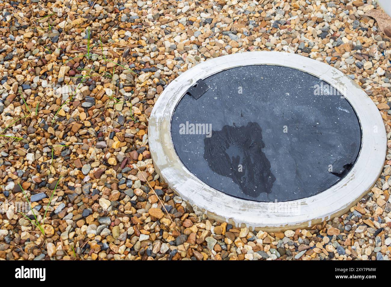 Septic tank cover underground waste treatment system Stock Photo - Alamy