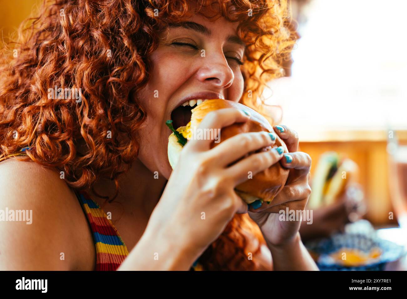 Multiethnic group of friends having meal at 80s vintage diner ...