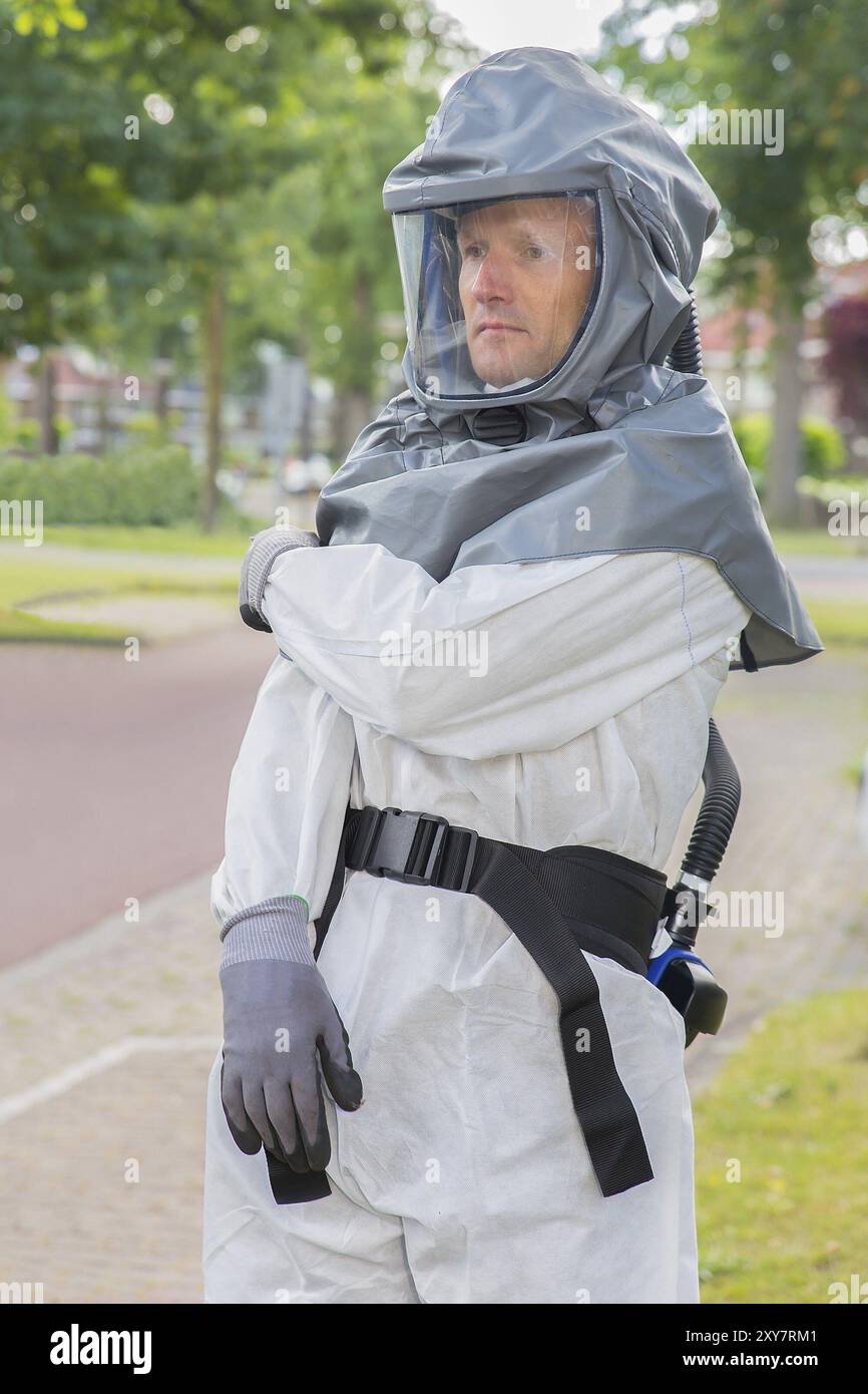 Insect exterminator dresses up in airtight working clothes in ...