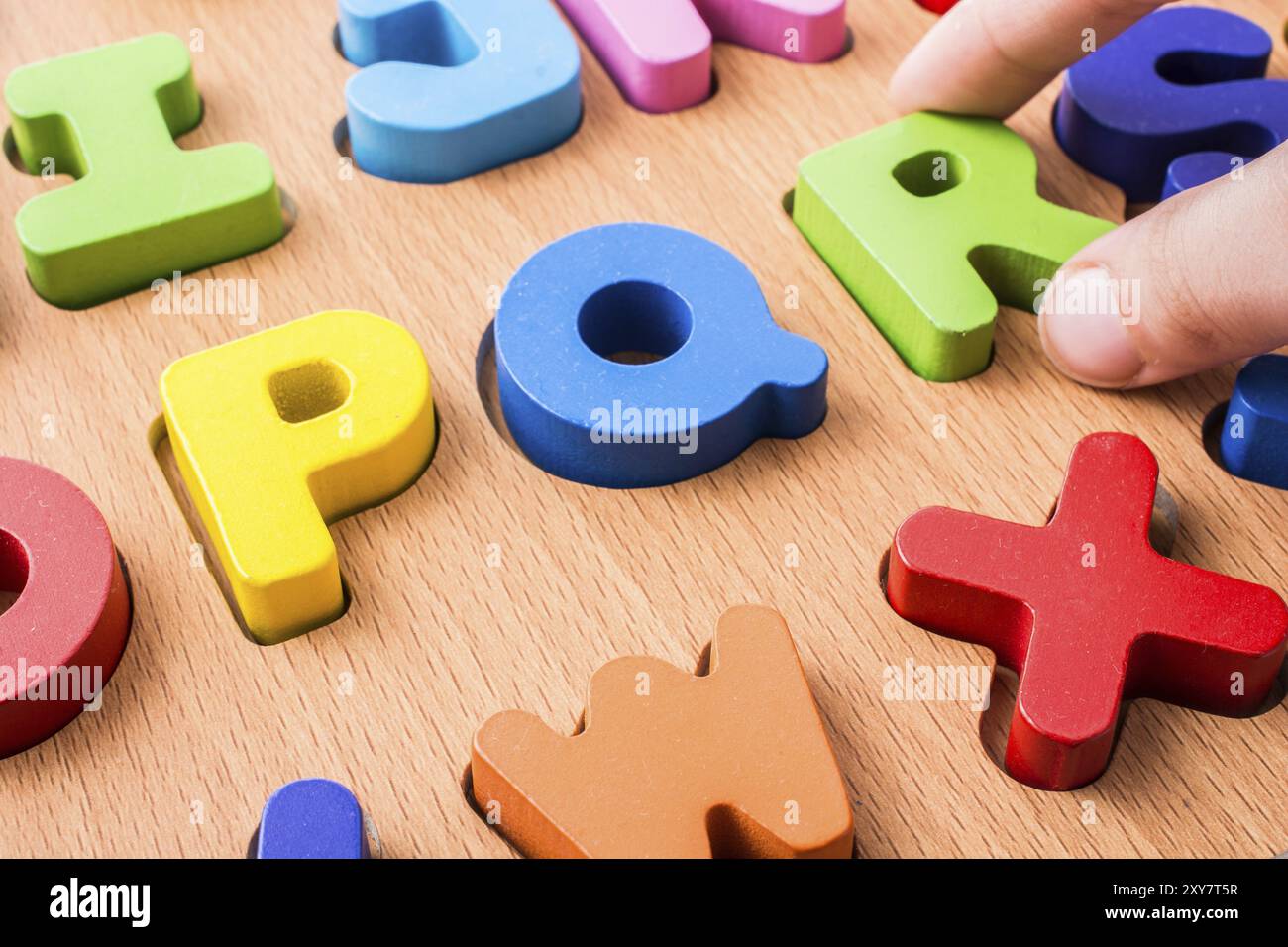 Colorful Letter of Alphabet R made of wood in hand Stock Photo - Alamy