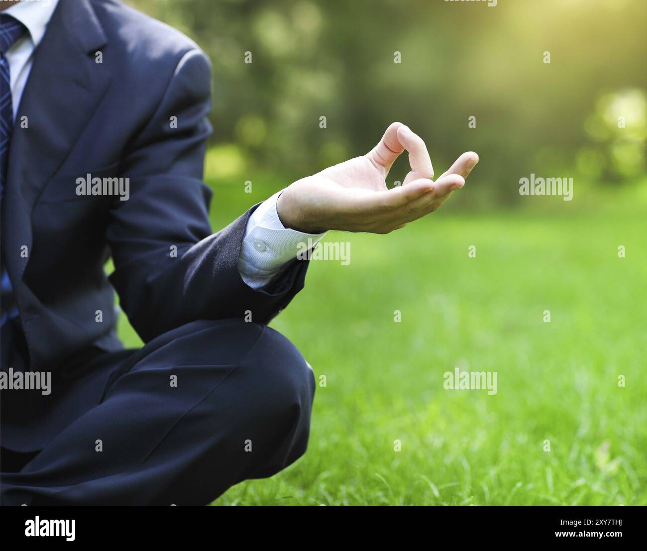 Business man relaxing in a park in the lotus position. Close up Stock ...