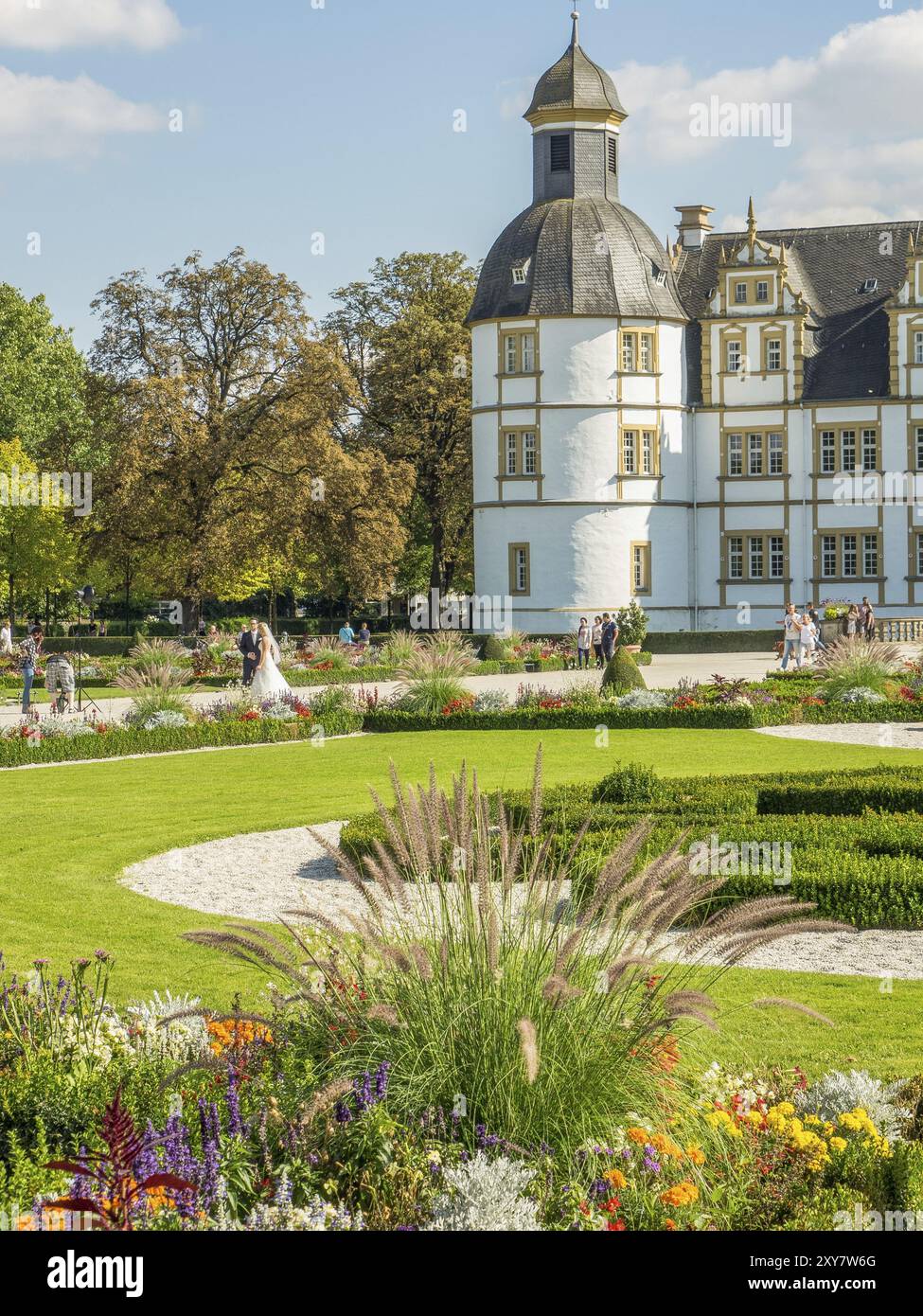 Historic castle with towers surrounded by a well-tended garden with ...