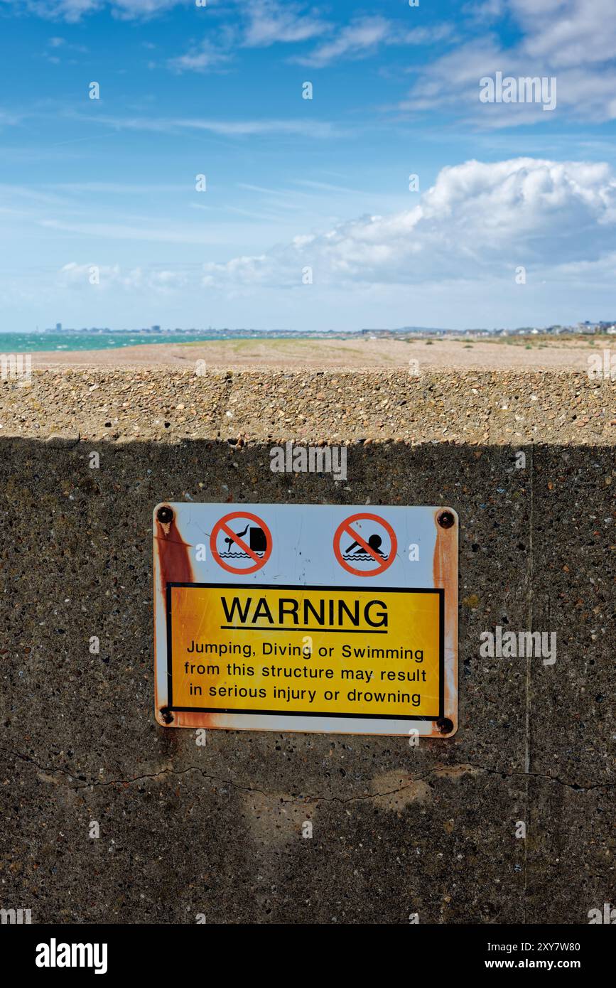 A warning notice on a breakwater at Shoreham harbour about the dangers ...