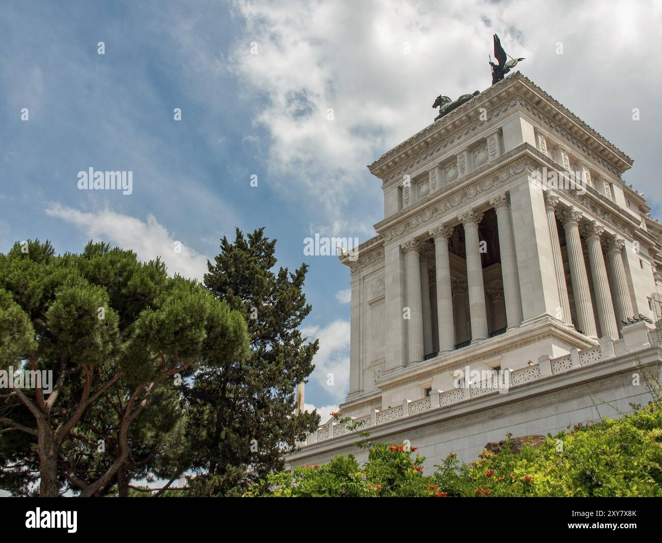 Side view of the Altar of the Nation in Rome with surrounding trees and ...